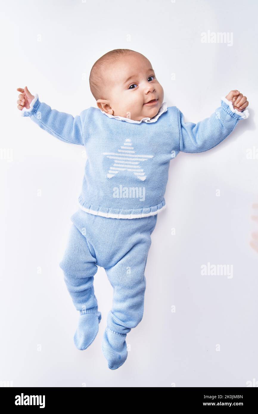 Adorable baby relaxed over white isolated background Stock Photo - Alamy