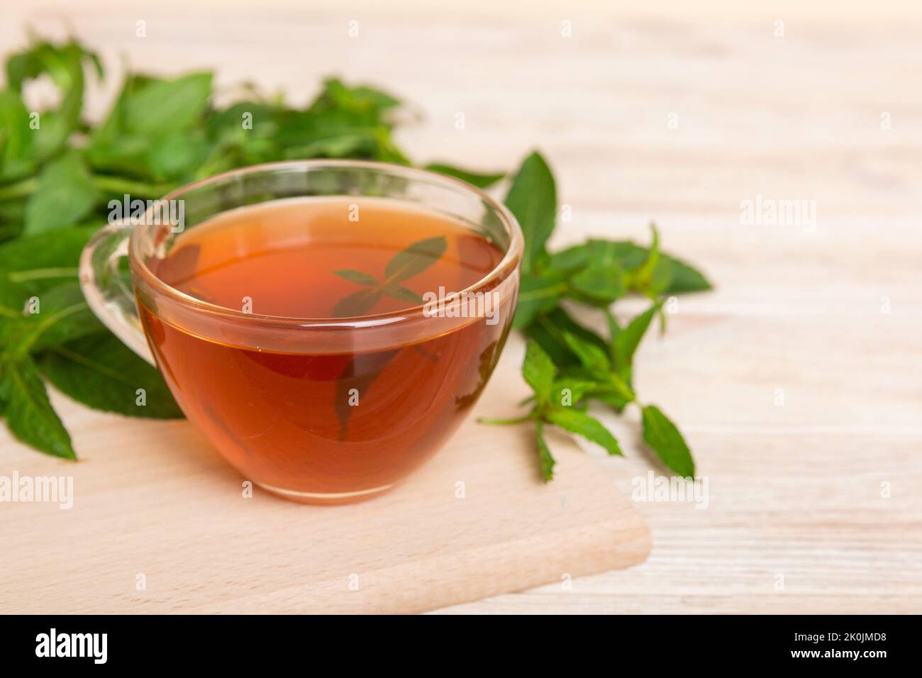 Cup of mint tea on table background. Green tea with fresh mint top view ...