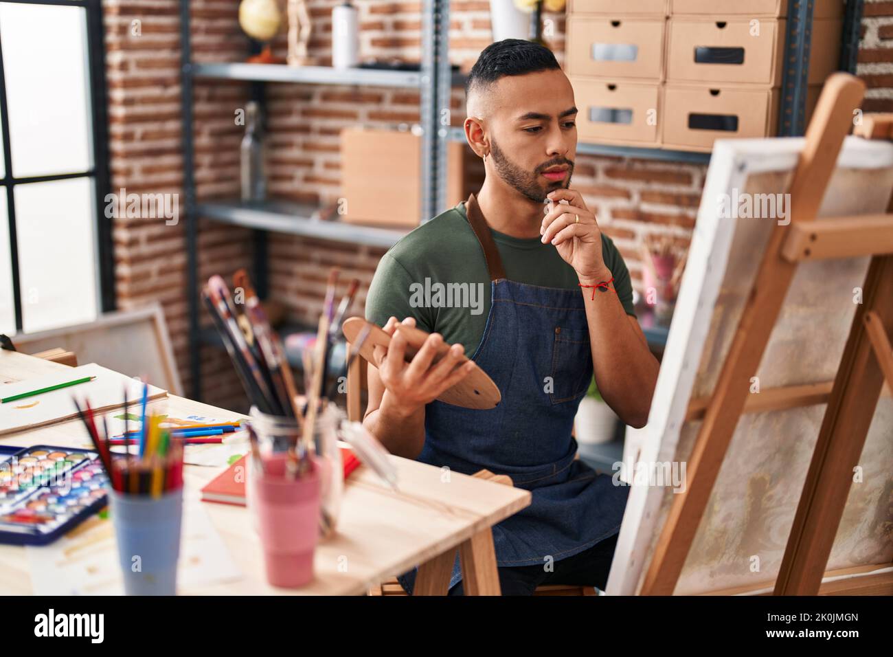 African american man artist drawing with doubt expression at art studio ...