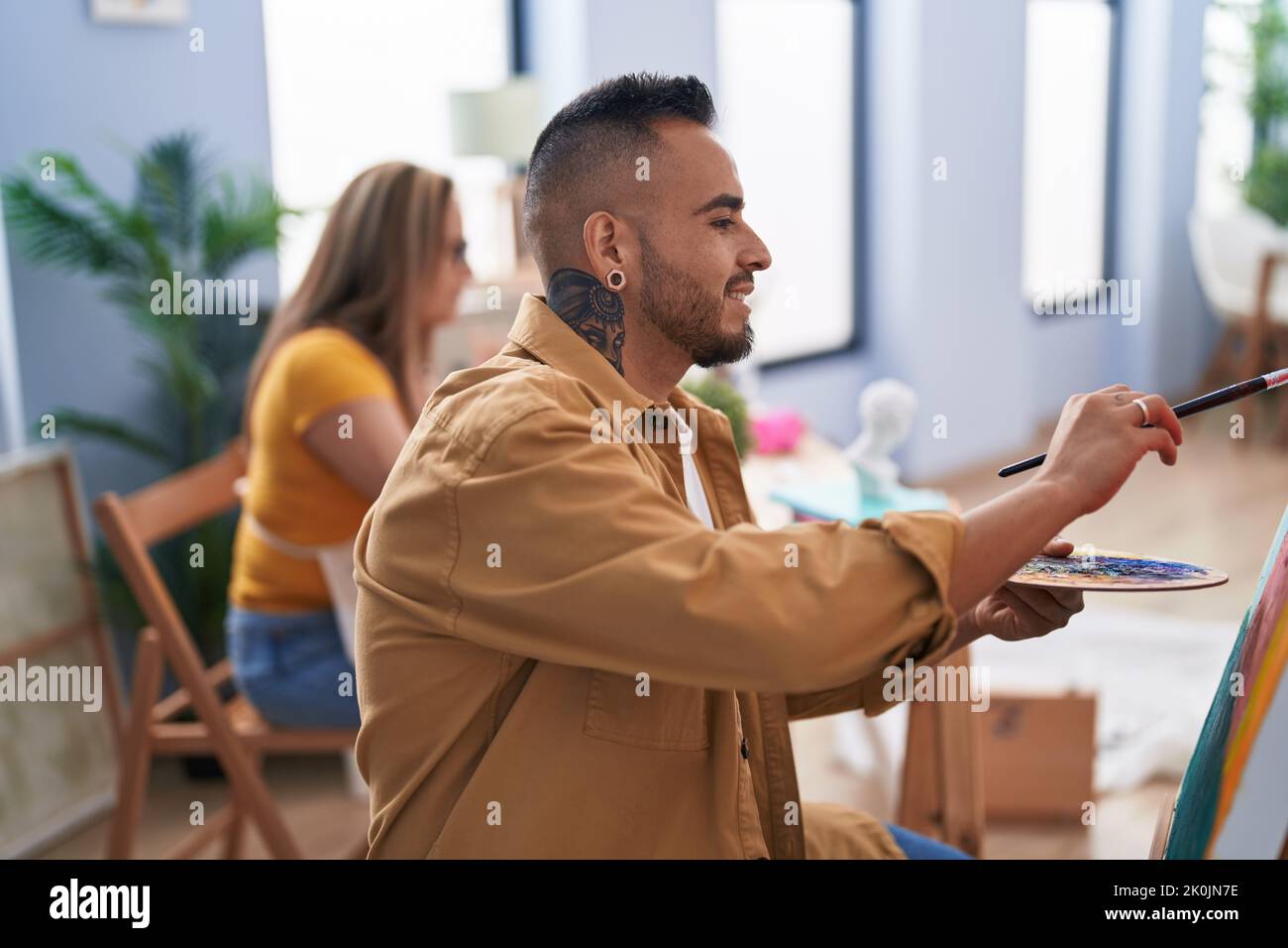 Man and woman artists smiling confident drawing at art studio Stock ...