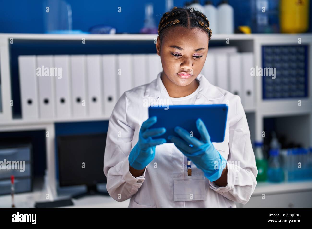 African american woman scientist using touchpad at laboratory Stock Photo - Alamy
