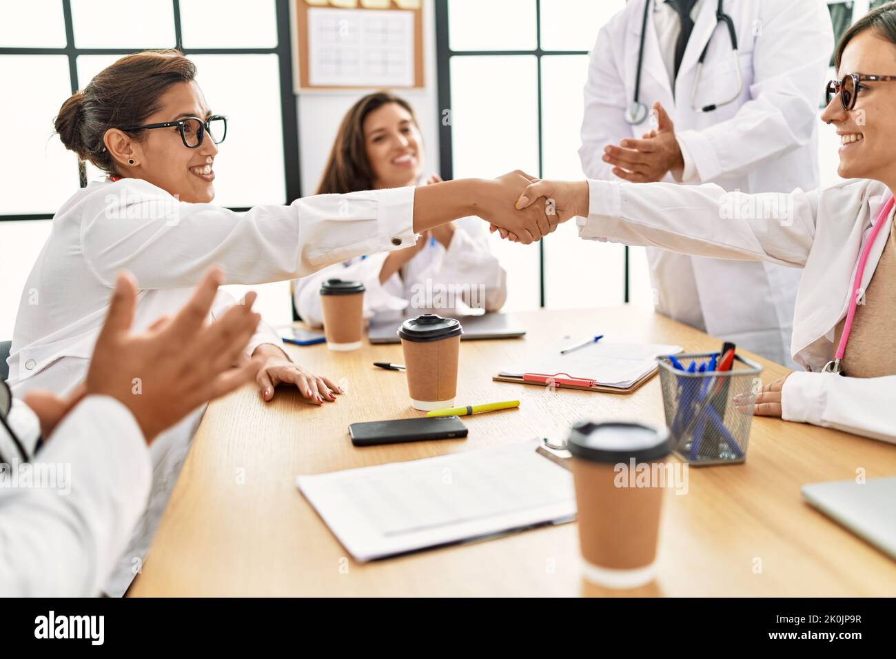 Group of doctor clapping to partners handshake in a medical meeting at ...