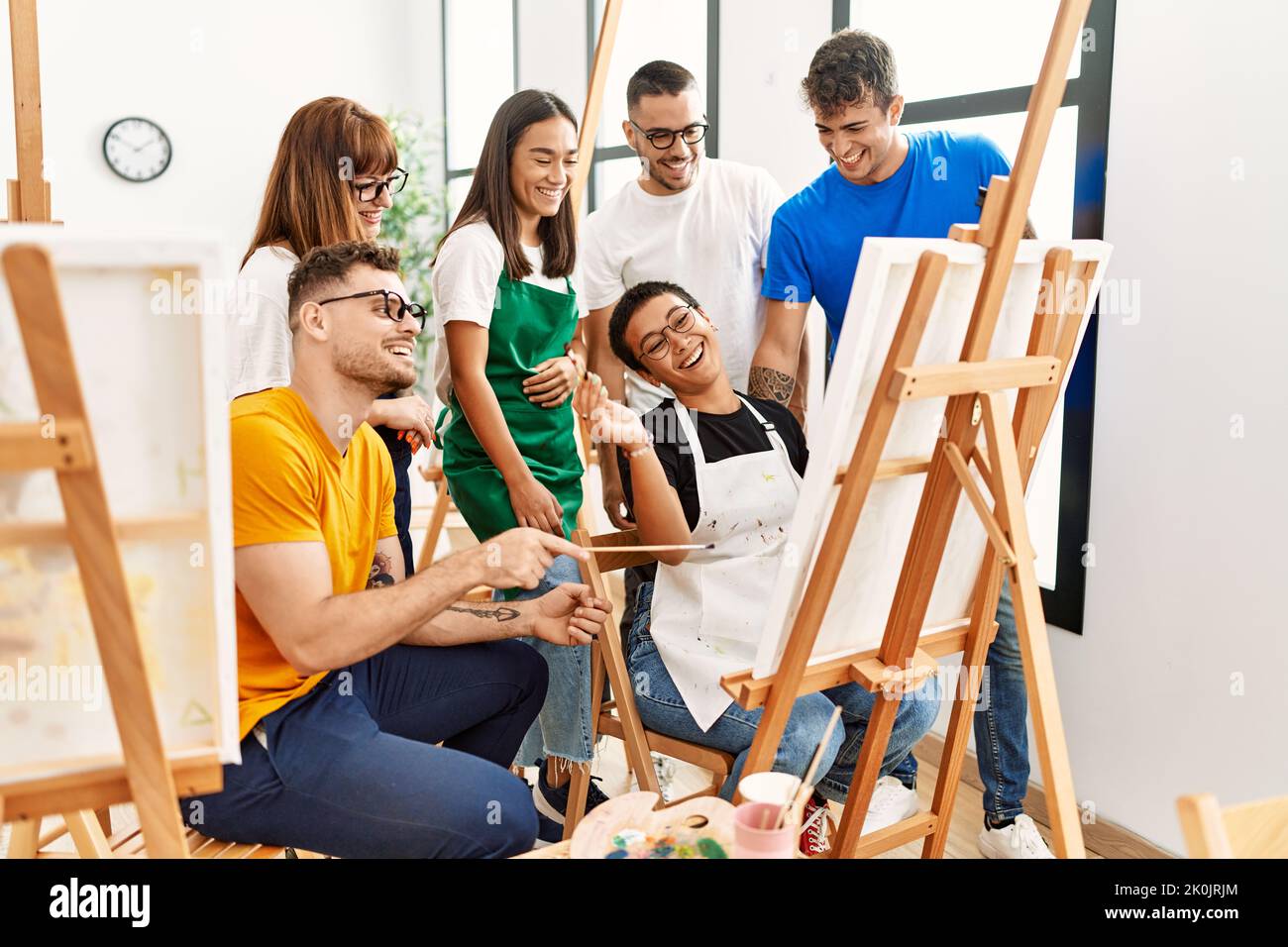 Group of people smiling happy and looking draw of partner at art studio ...