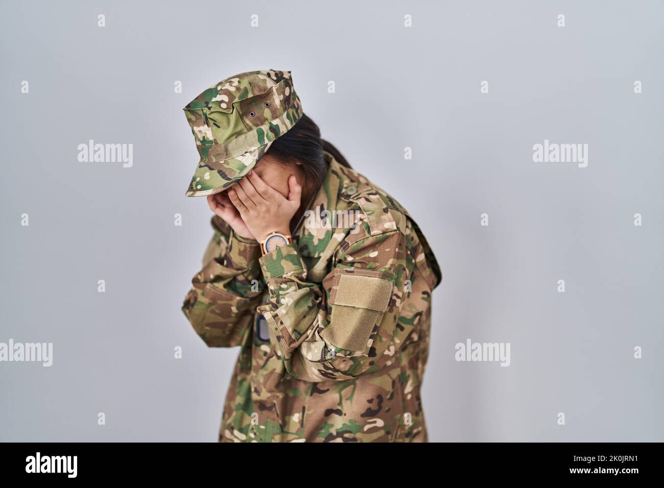 Young south asian woman wearing camouflage army uniform with sad ...