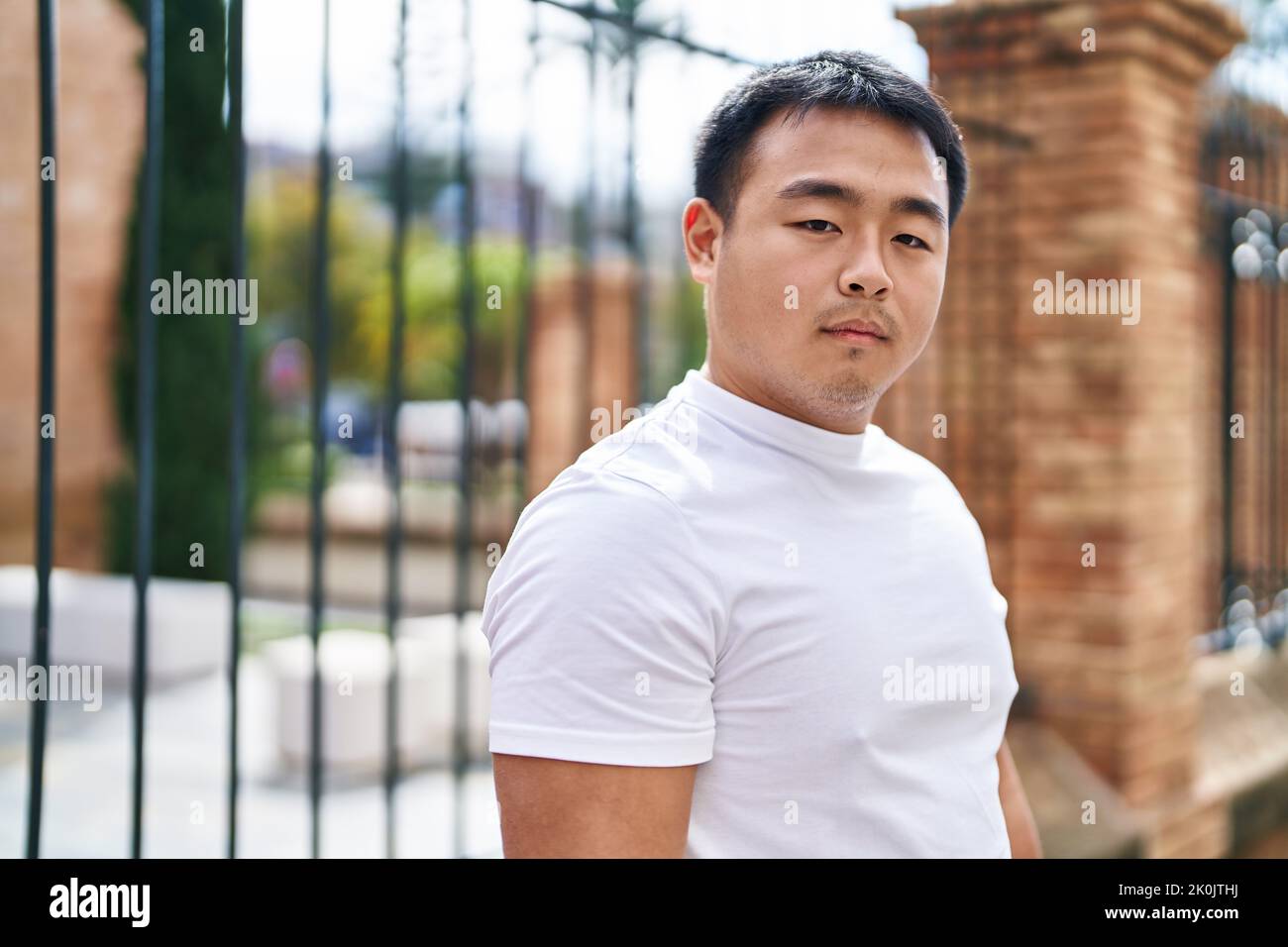 Young chinese man standing with relaxed expression at street Stock ...