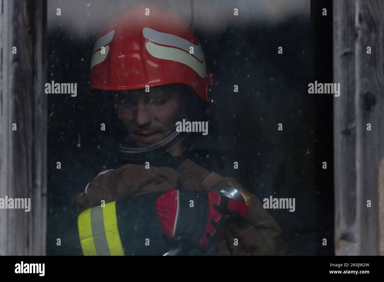 Firefighter hero carrying baby girl out from burning building area from ...