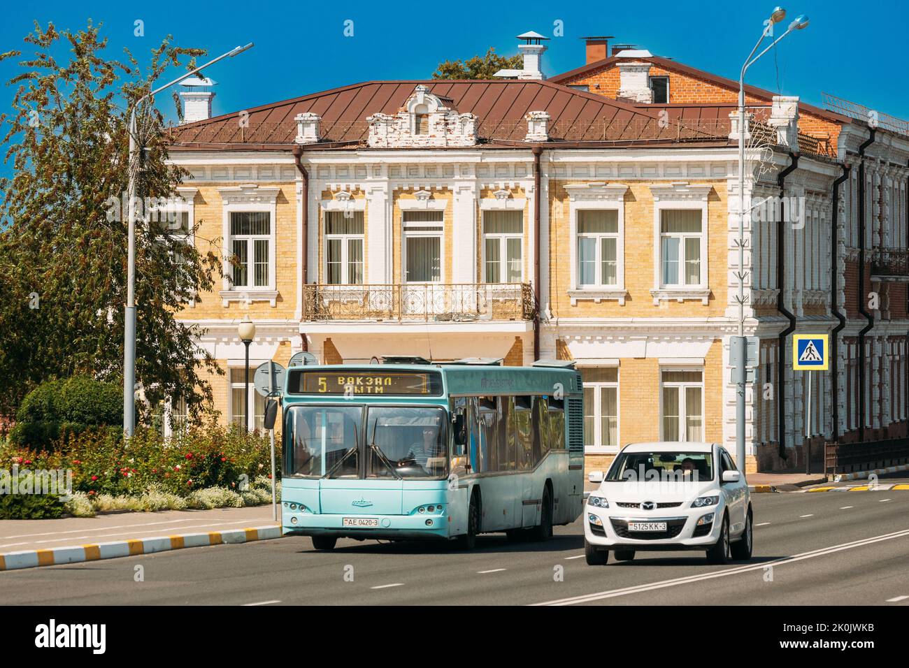 Rechytsa, Belarus. City Bus And Car Ride Against Background Of Old ...