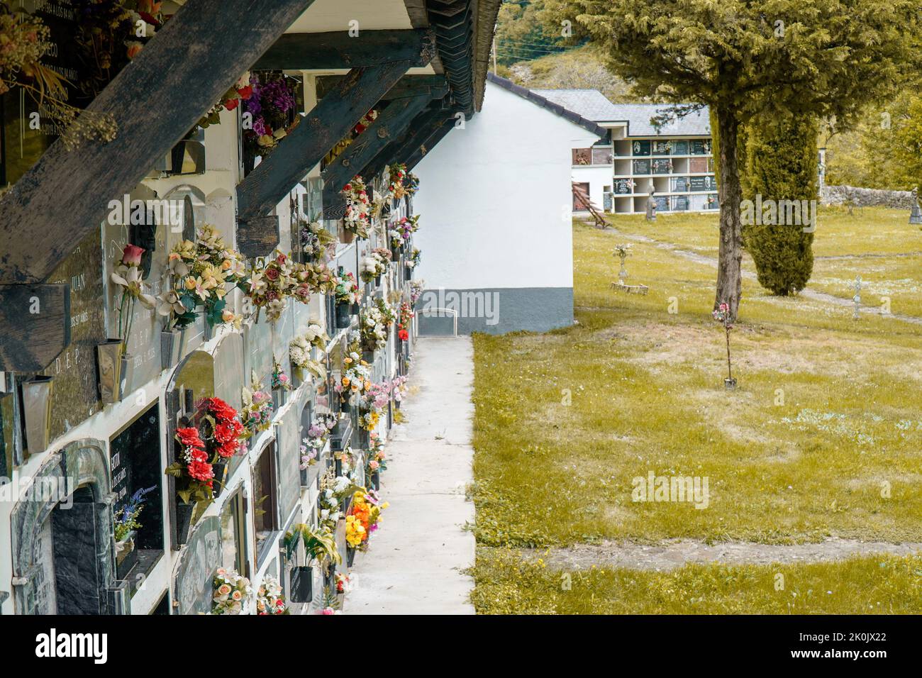 Day of the dead in Spain. Cemetery with tombs surrounded by mountains ...