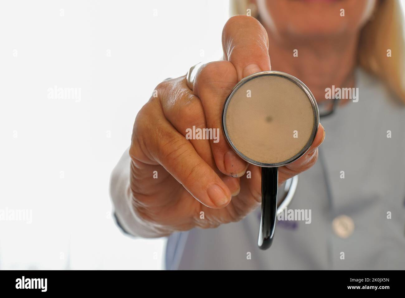 Nurse show a stethoscope with white background Stock Photo - Alamy