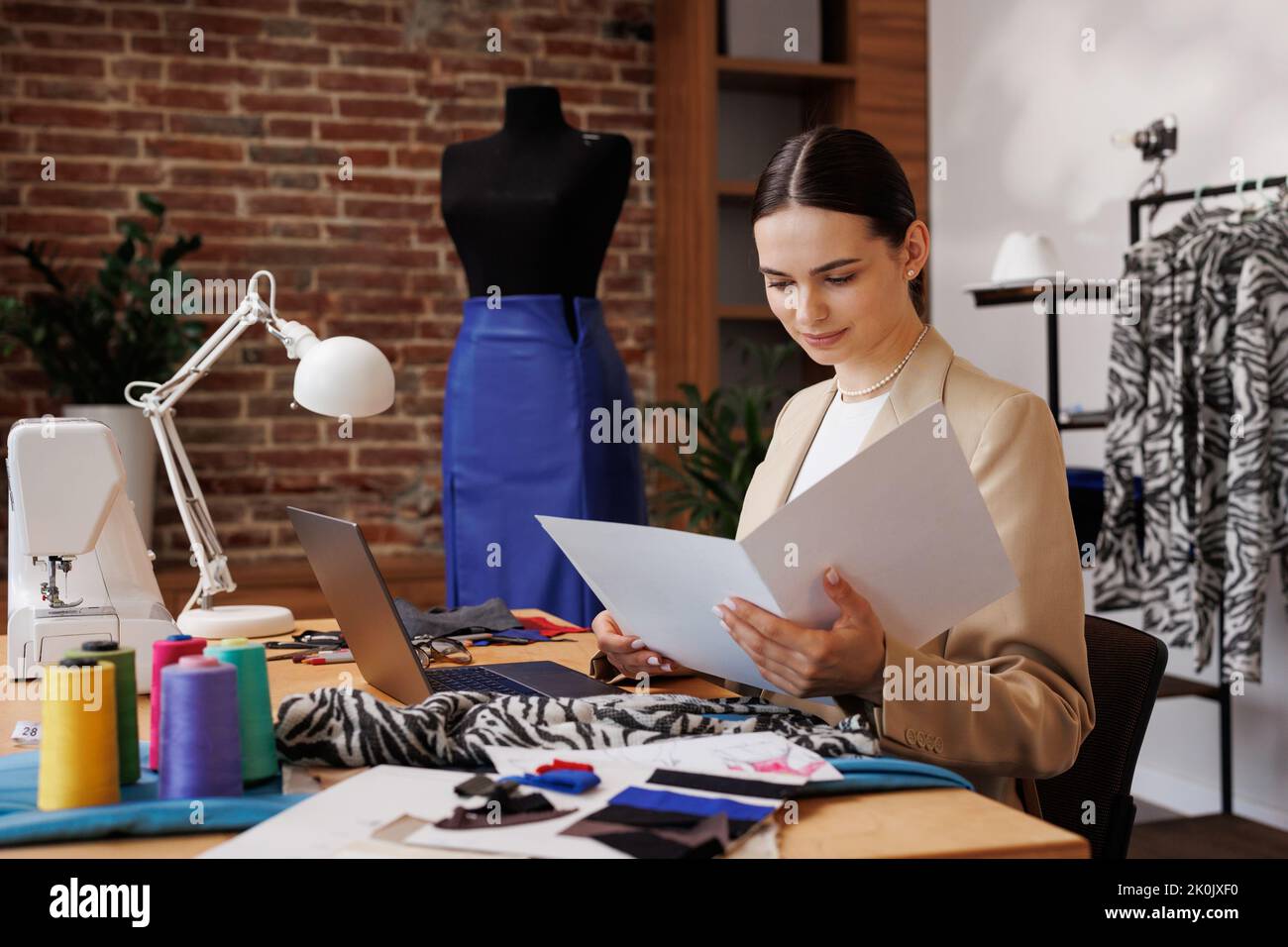 Portrait of a young girl of a fashion designer against the background ...