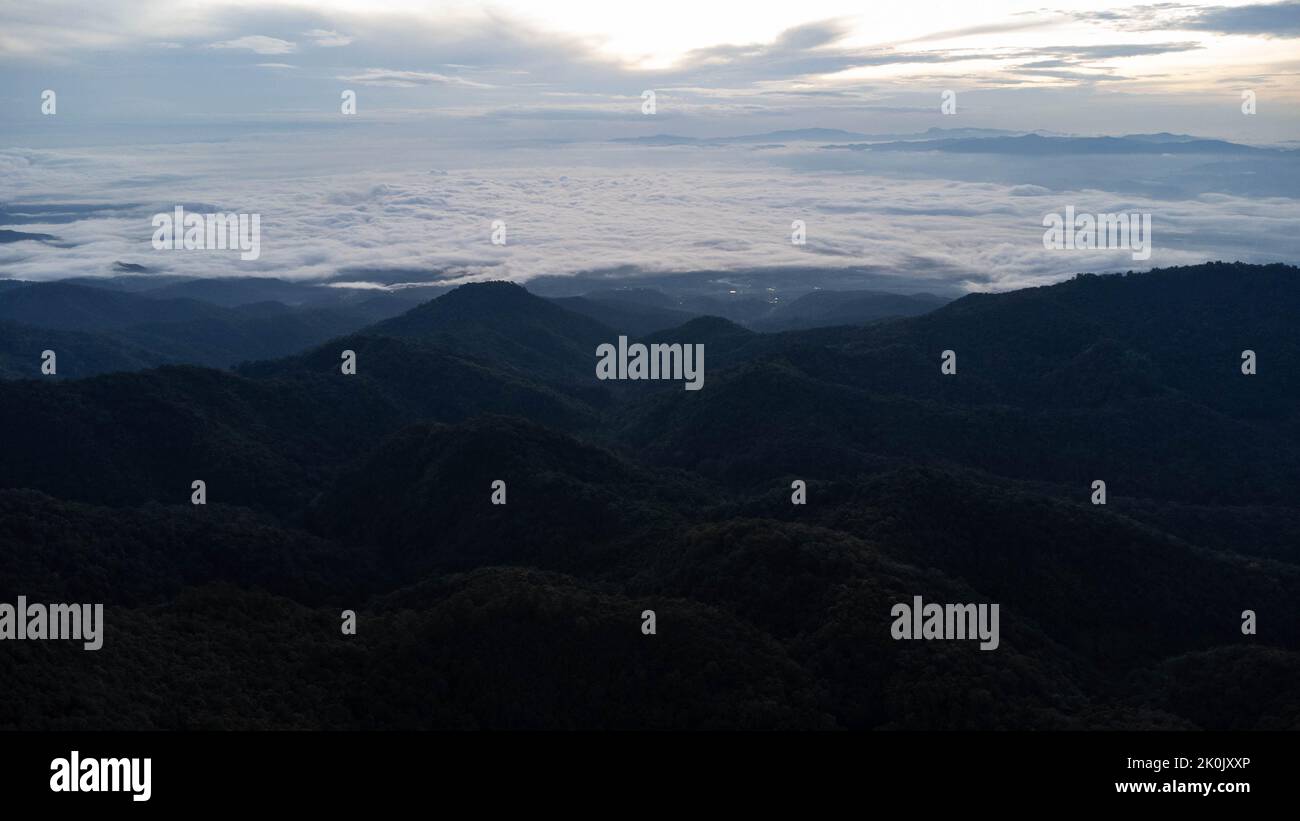 Aerial view of sea of fog on tropical mountains in the early morning ...