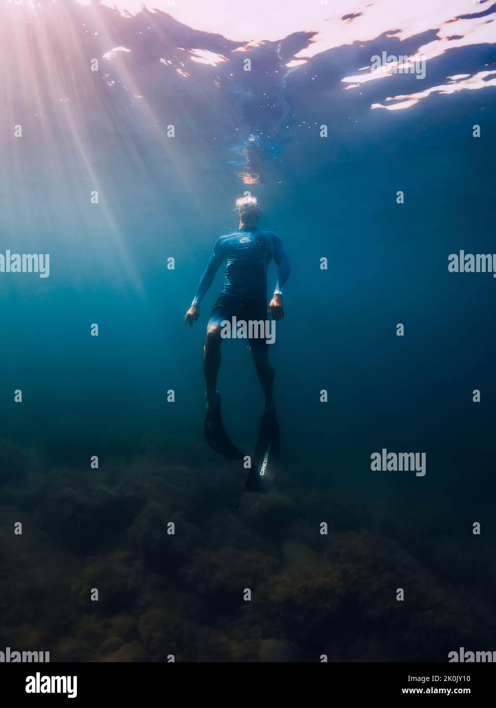 August 07, 2021. Varna, Bulgaria. Men freediver with fins in blue sea ...