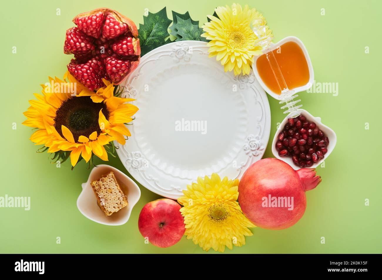 Rosh Hashanah. Ripe pomegranate, apple, honey and sunflower, yellow ...