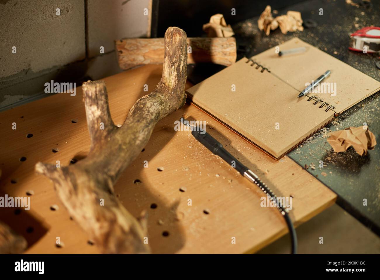 Carpenter workplace with notepad and power working tools graver for ...