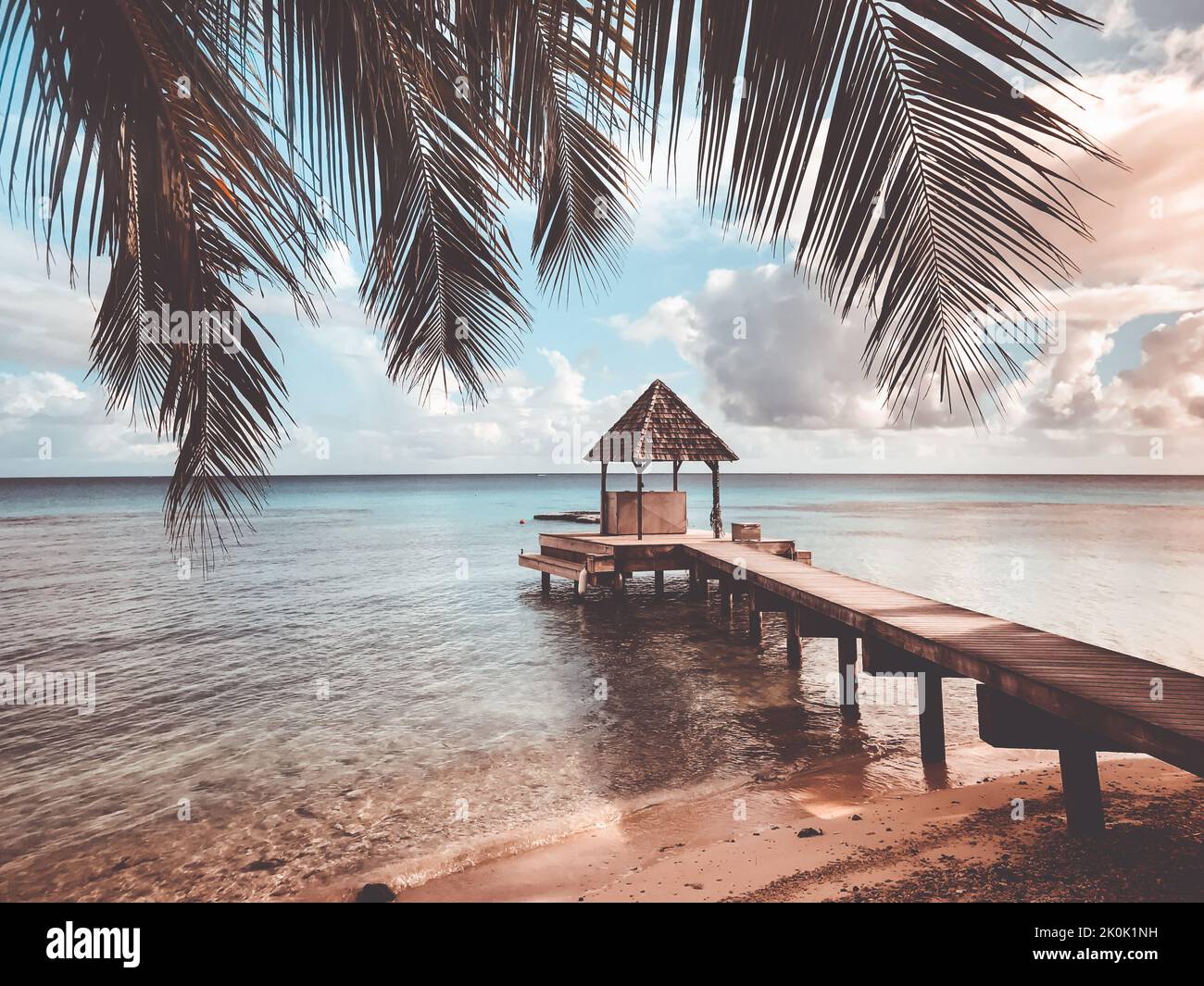 Wooden gazebo on pier. Tropical island beach with coconut palm tree ...