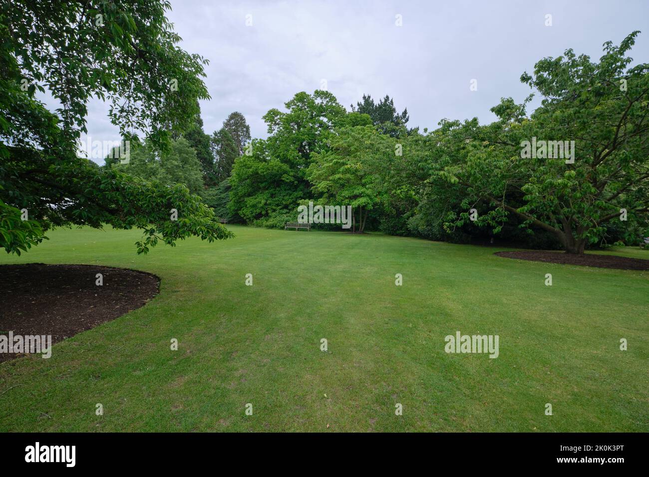 A view of a green, groomed, perfect expanse of lawn on a grey, rainy ...