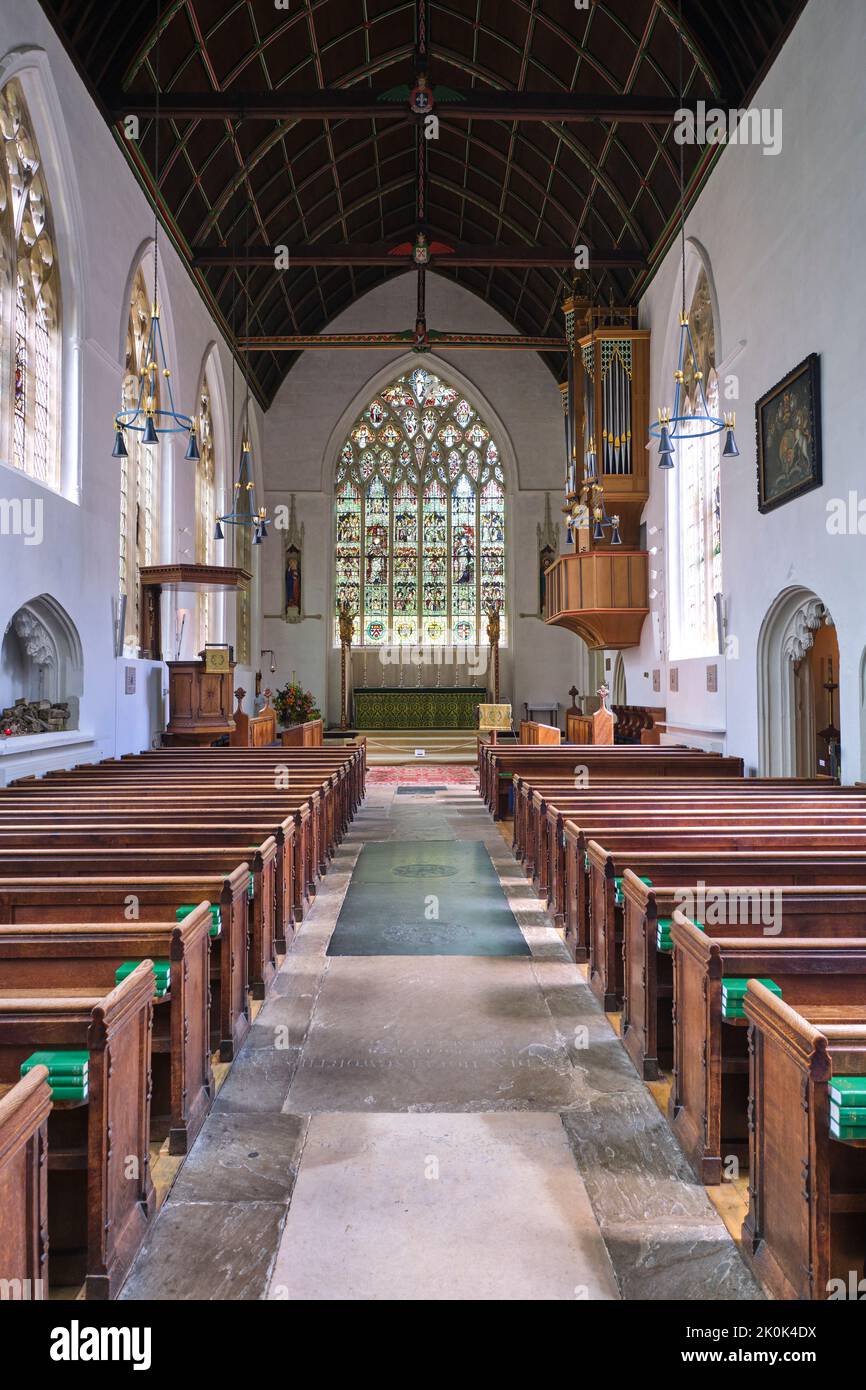 A view of the central nave with whitewashed walls, organ and stained ...