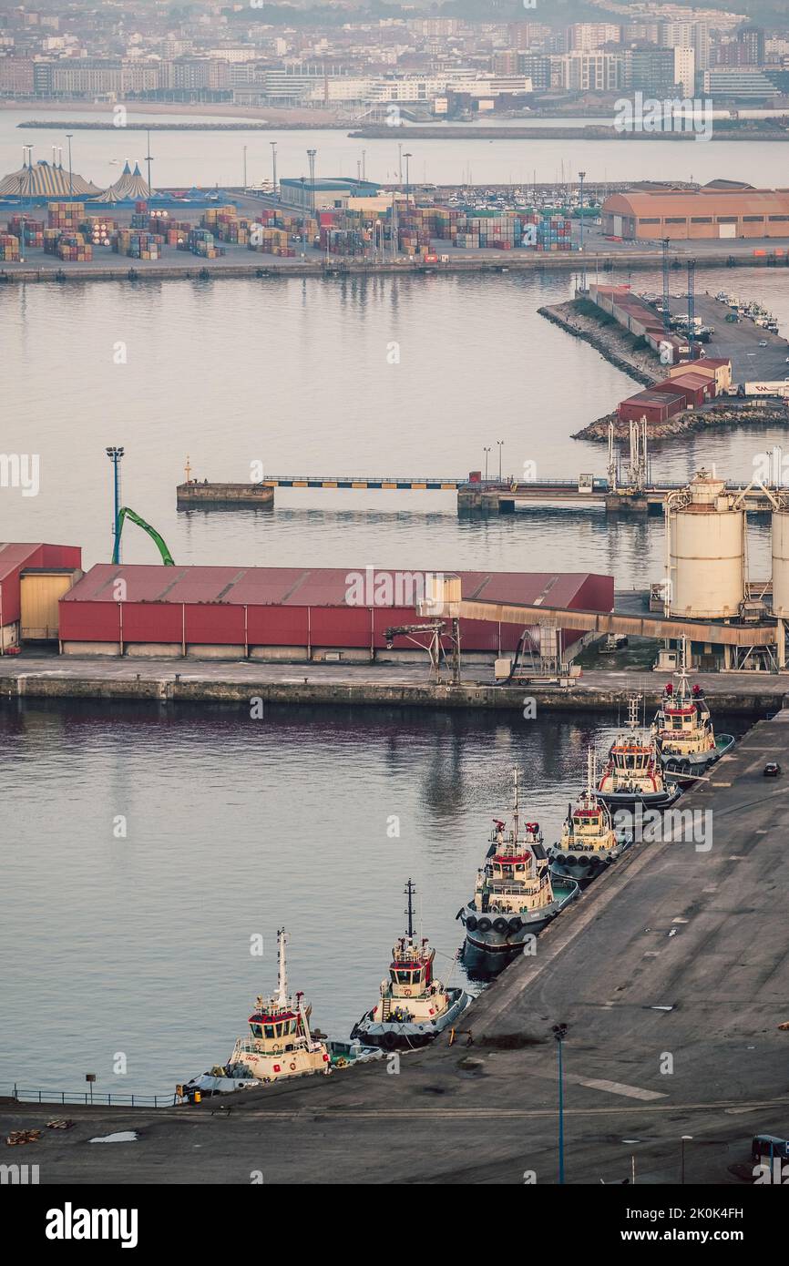 Aerial view of cargo boat with helipad moored at concrete pier on ...