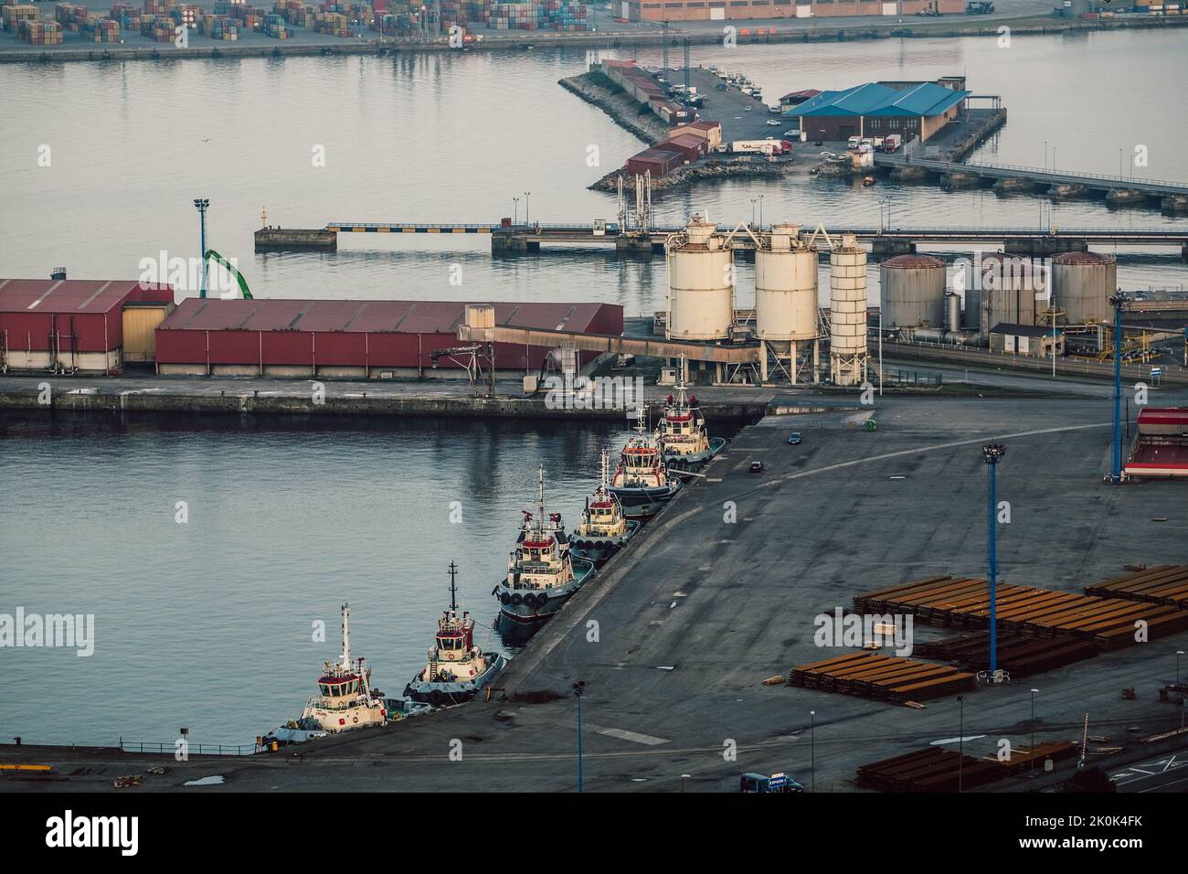 Aerial view of cargo boat with helipad moored at concrete pier on ...