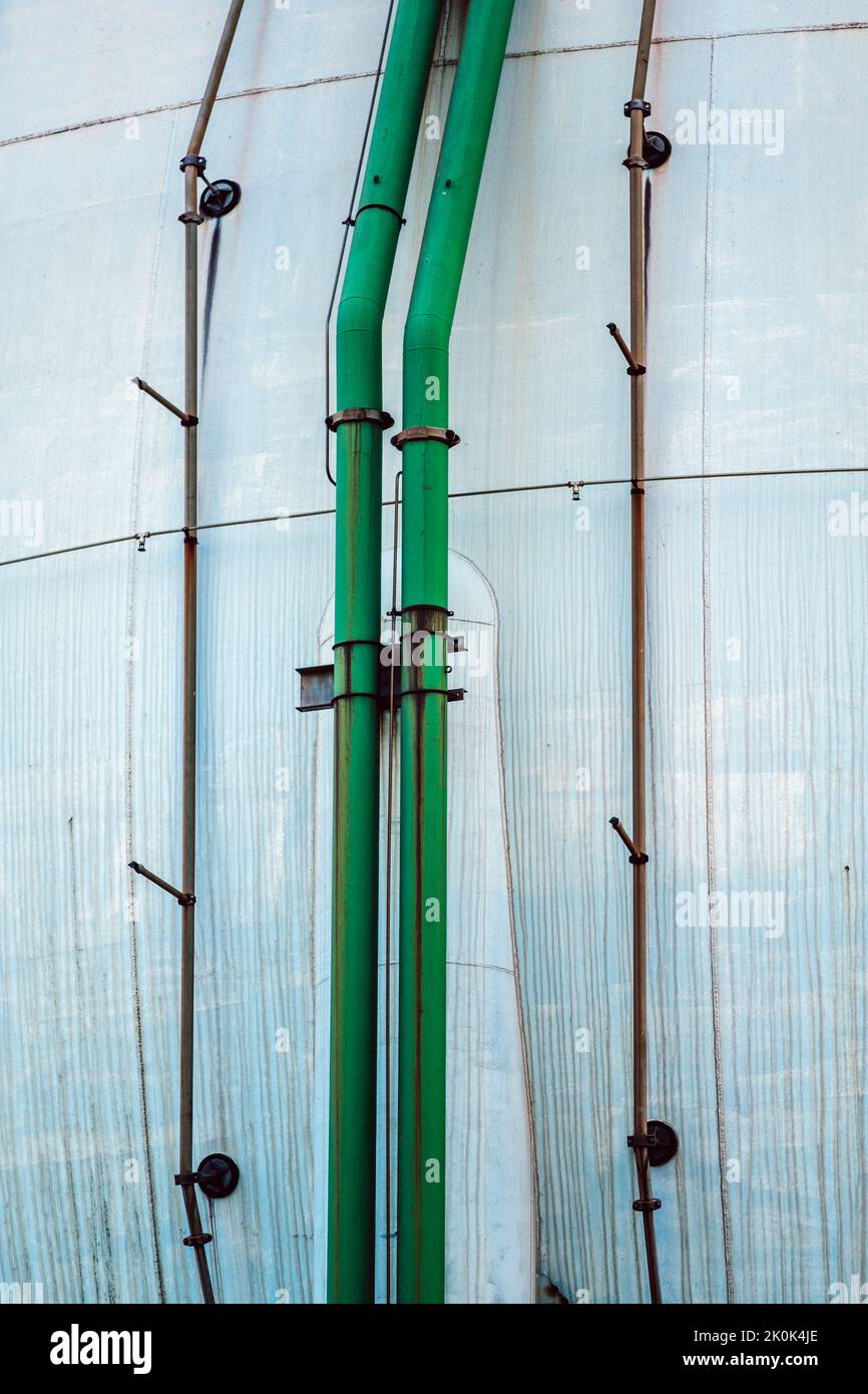 Green thin pipes attached to metal spherical fuel deposit in detail ...