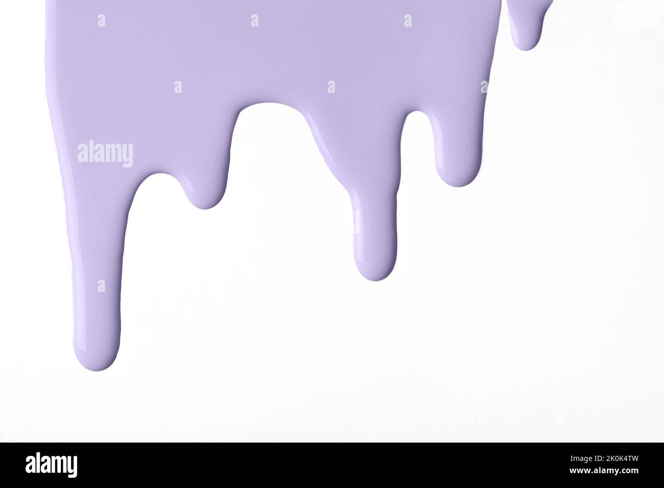 Light purple liquid drops of paint color flow down on isolated white ...