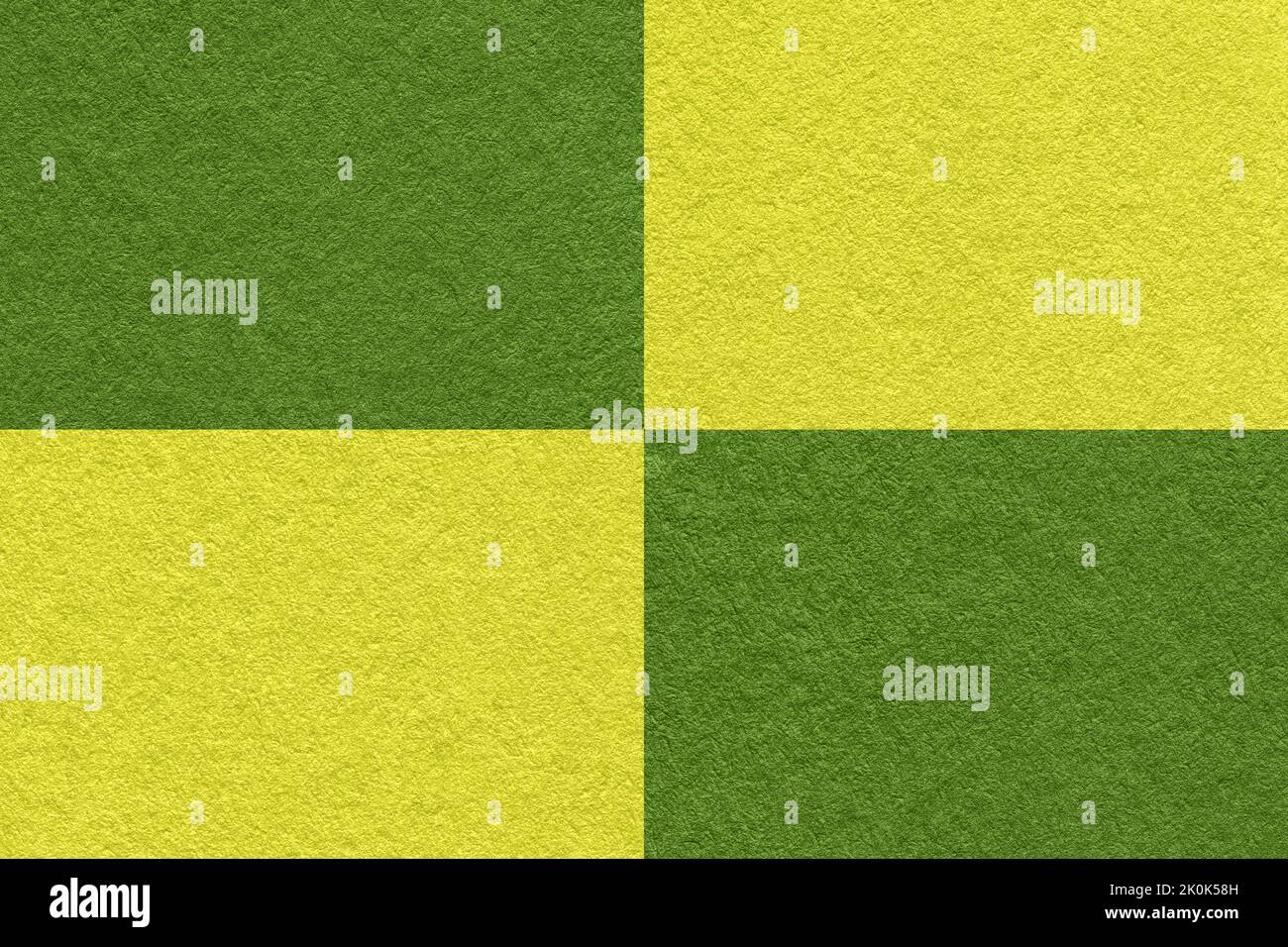 Texture of craft dark green and yellow paper background with cells ...