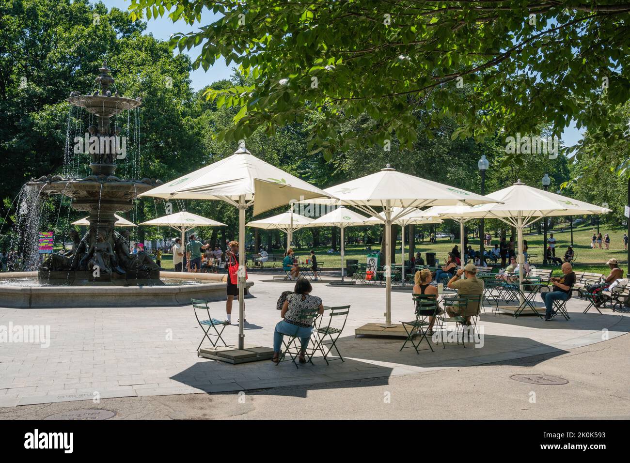 Boston, MA, US- June 25, 2022: People walk by fountain in urban park ...