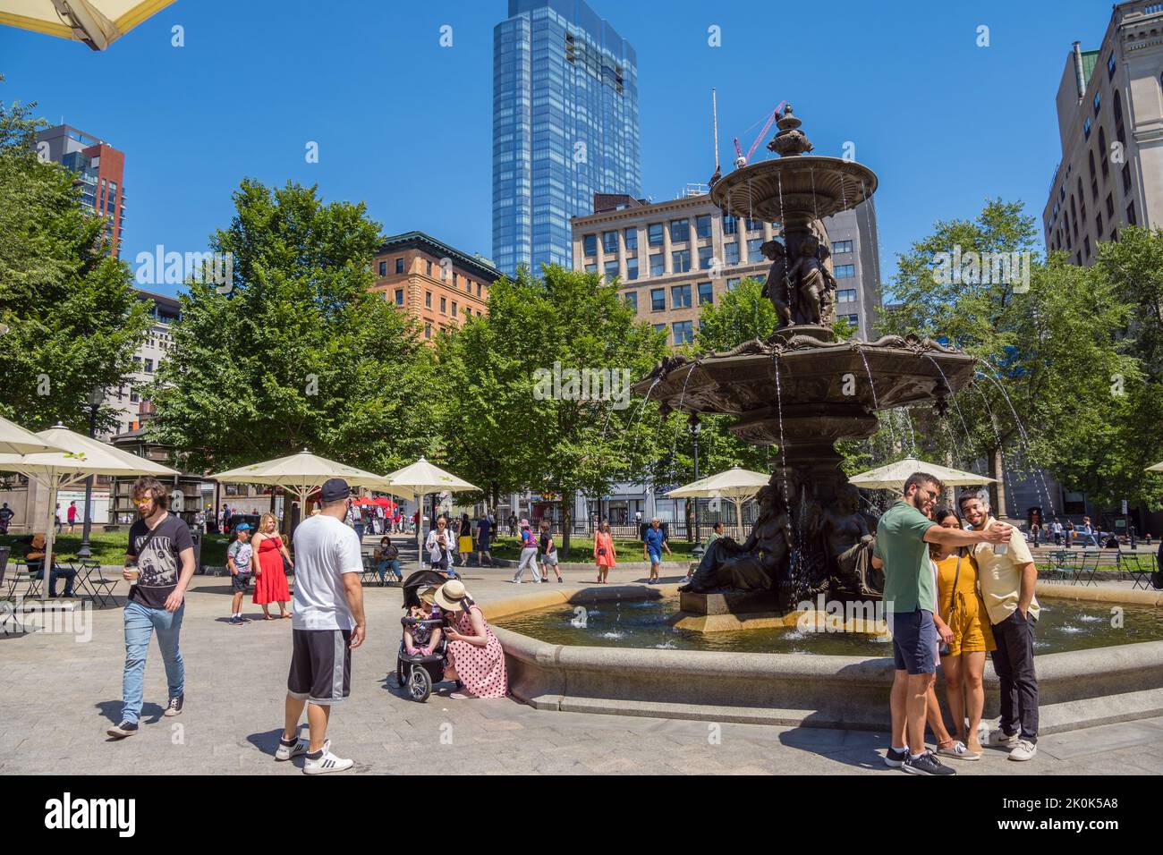 Boston, MA, US- June 25, 2022: People walk by fountain in urban park ...