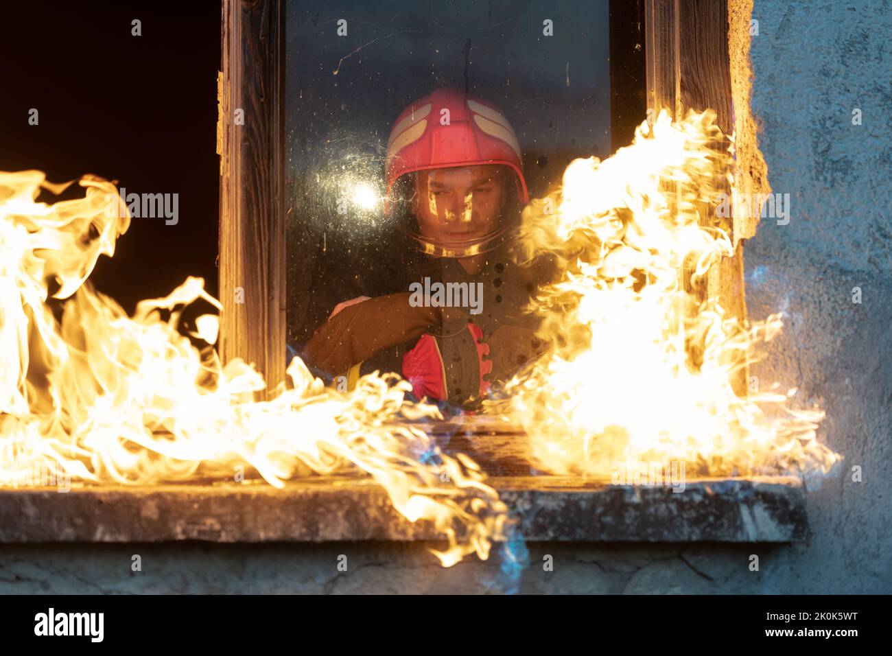 Firefighter hero carrying baby girl out from burning building area from ...