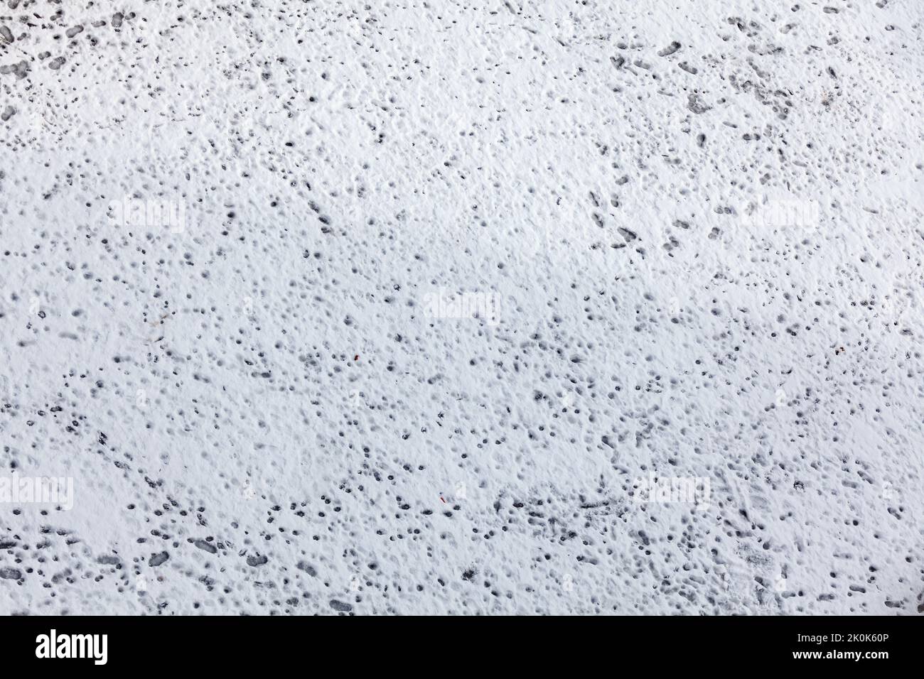 Snowy surface with footprints . White background covered by snow ...