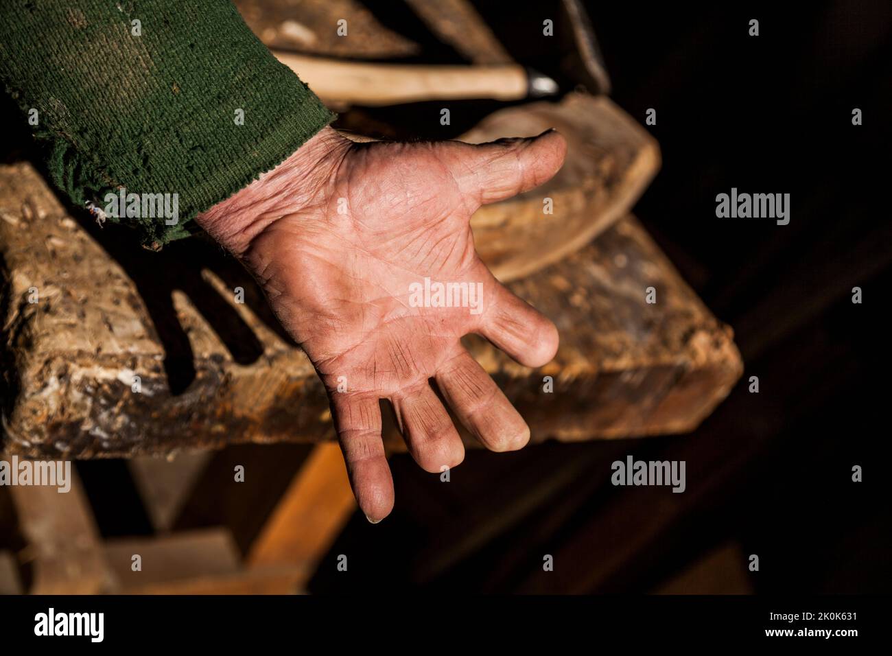 From above fingerless hand of anonymous elderly woodworker over ...