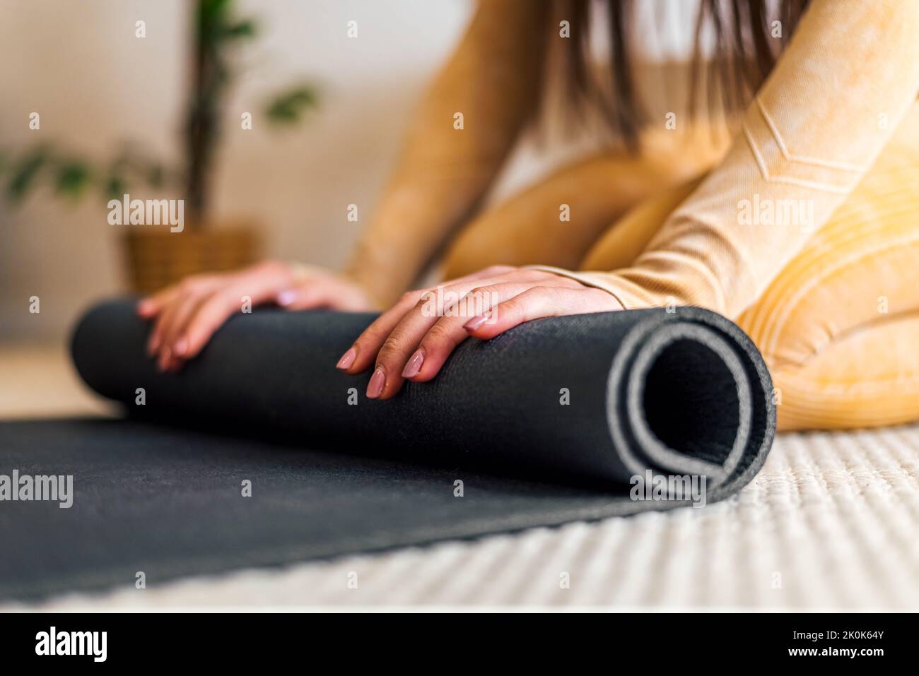Black foam yoga mat, being put on the floor for morning exercise, at ...