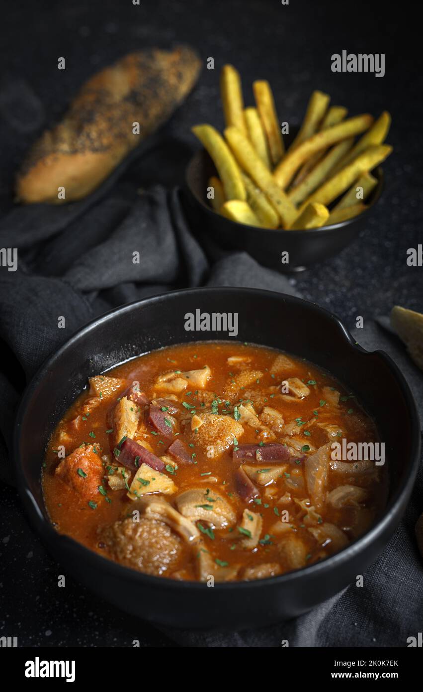 From above of tasty callos a la madrilena in black bowl near French ...