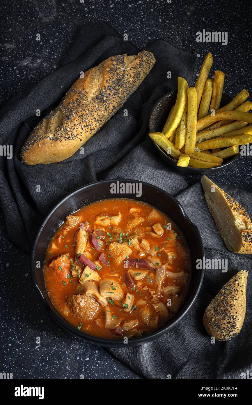 From above of tasty callos a la madrilena in black bowl near French ...