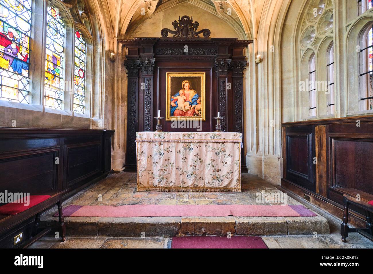 A quiet, small, simple side altar with a painting of the Virgin Mary ...