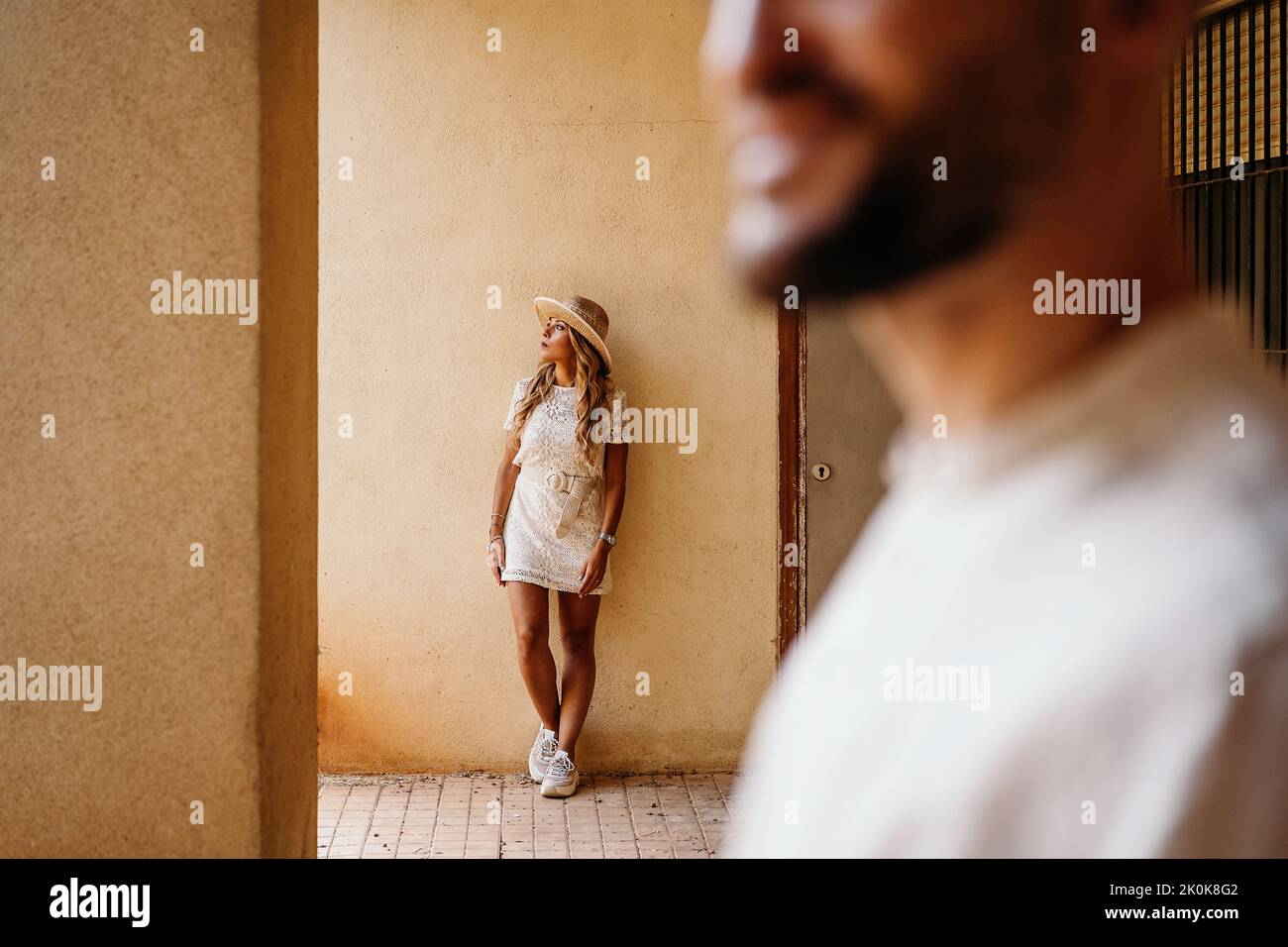 Gorgeous adult lady in elegant white dress and straw hat with brim ...