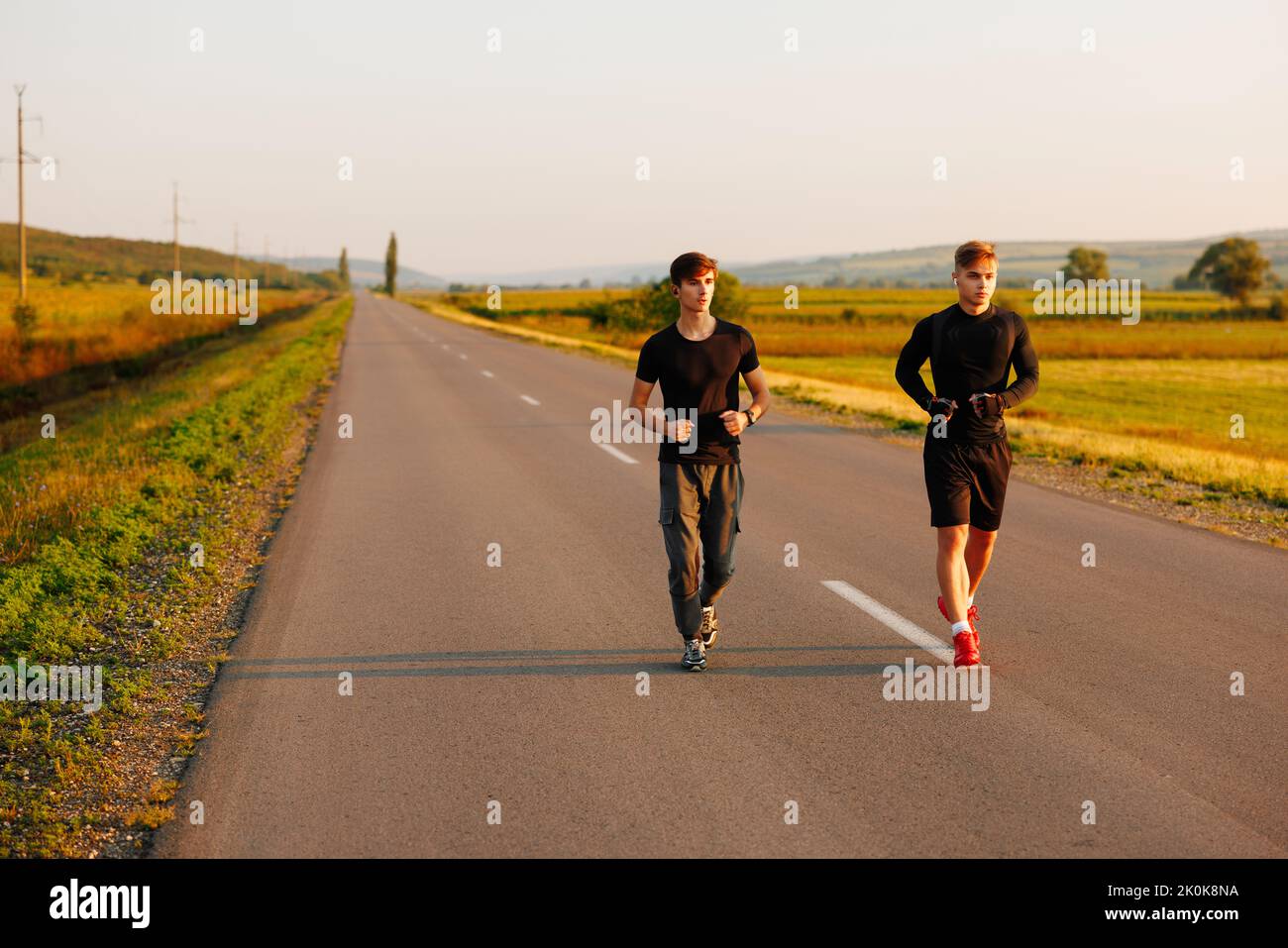 Young friendsrunning sprinting on road. Fit runner fitness runner ...