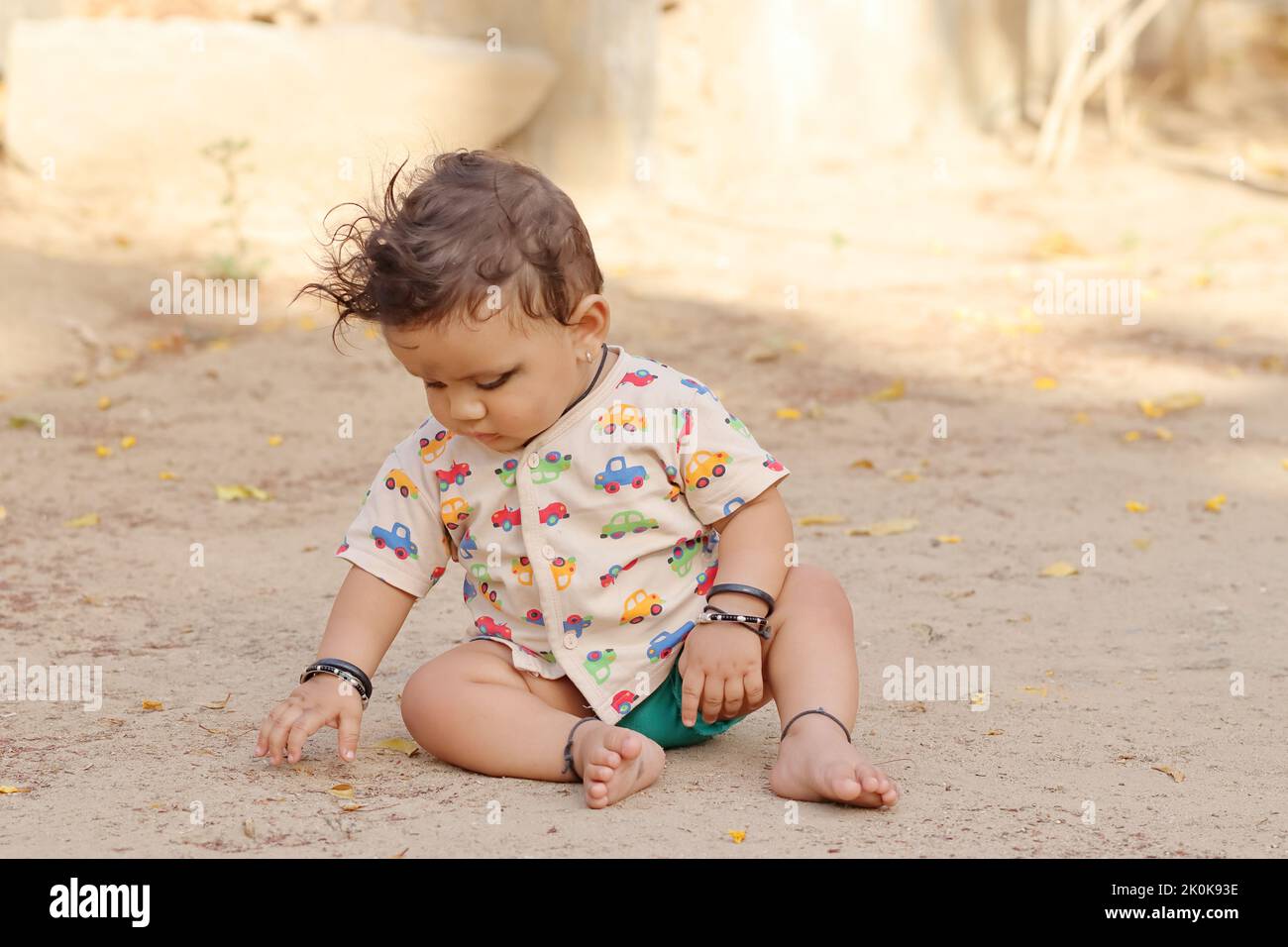 Close-up photo of Adorable Indian baby boy at outdoor and playing with ...