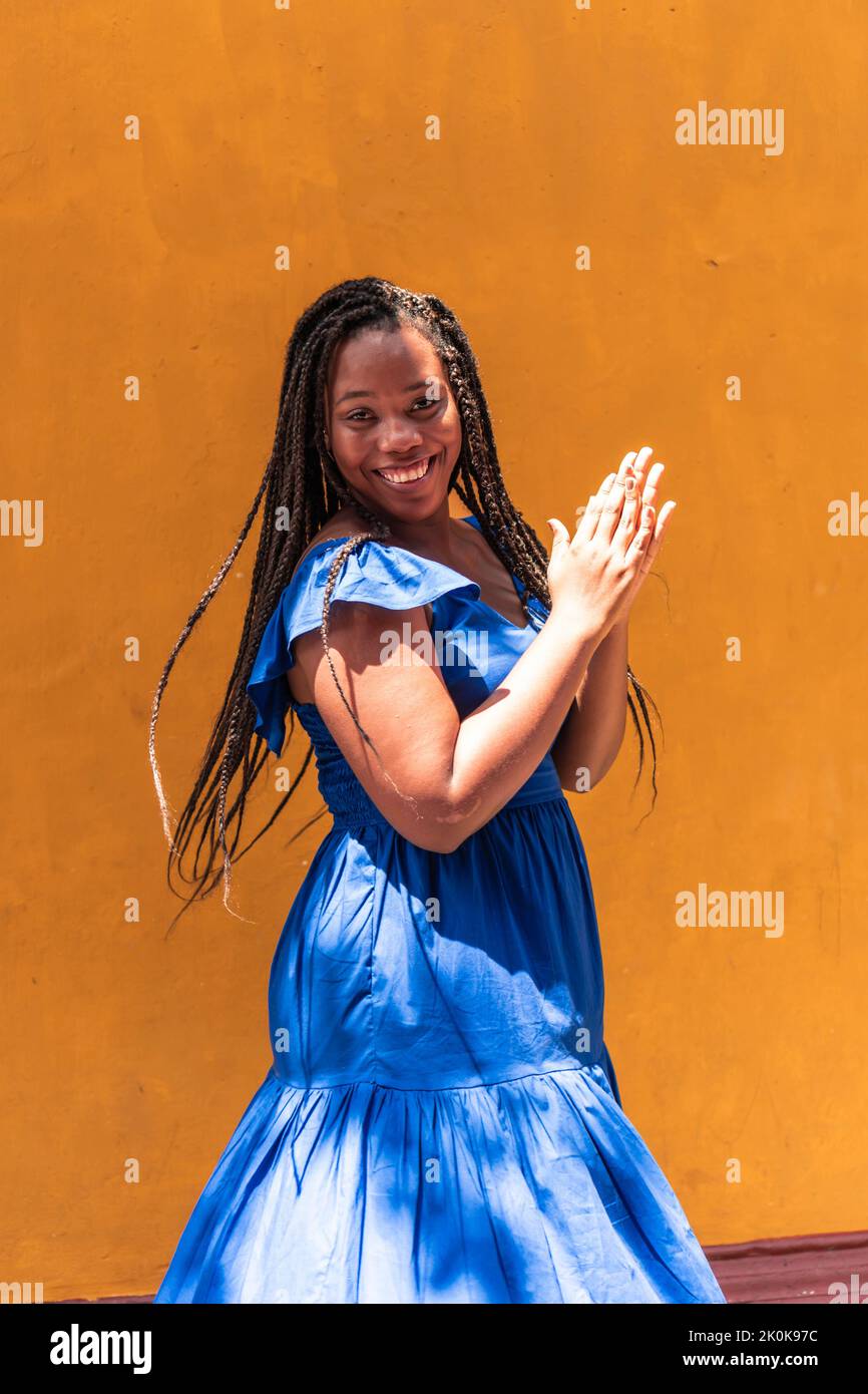 Side view of content African American female with braids and in dress ...
