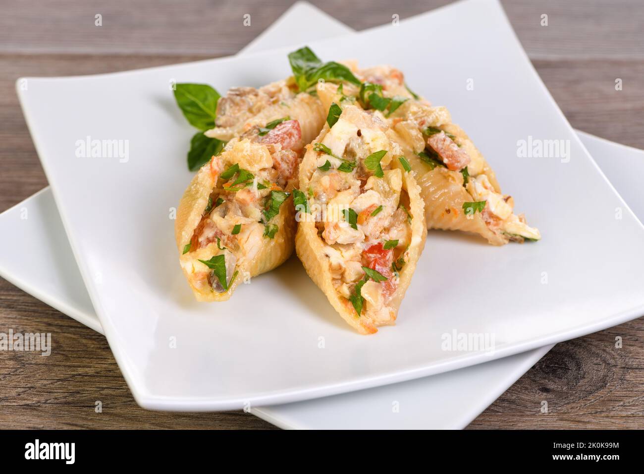 Pasta Conchiglie stuffed with tender chicken pieces, mushrooms and ...