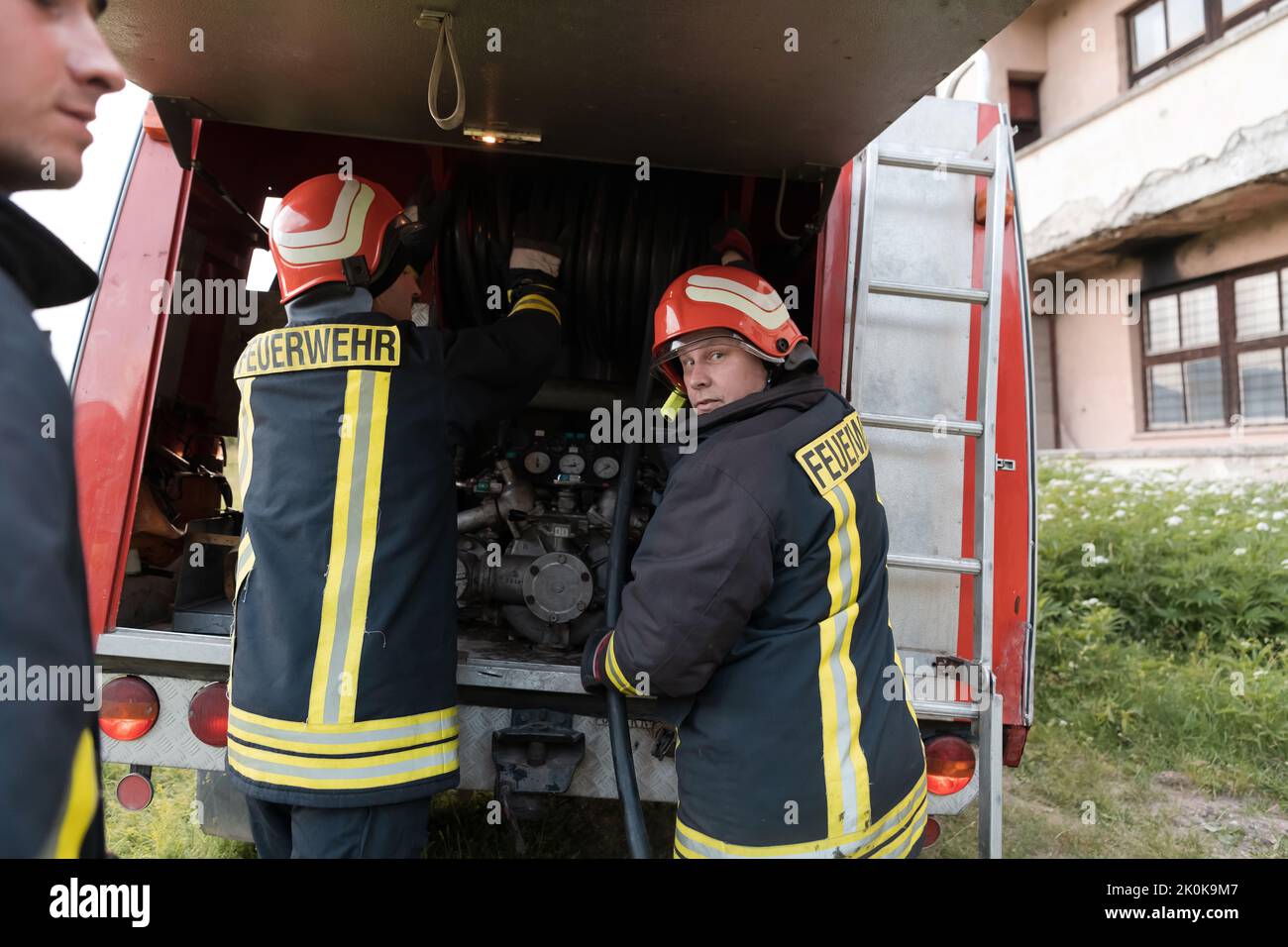 Group of fire fighters standing confident after a well done rescue ...