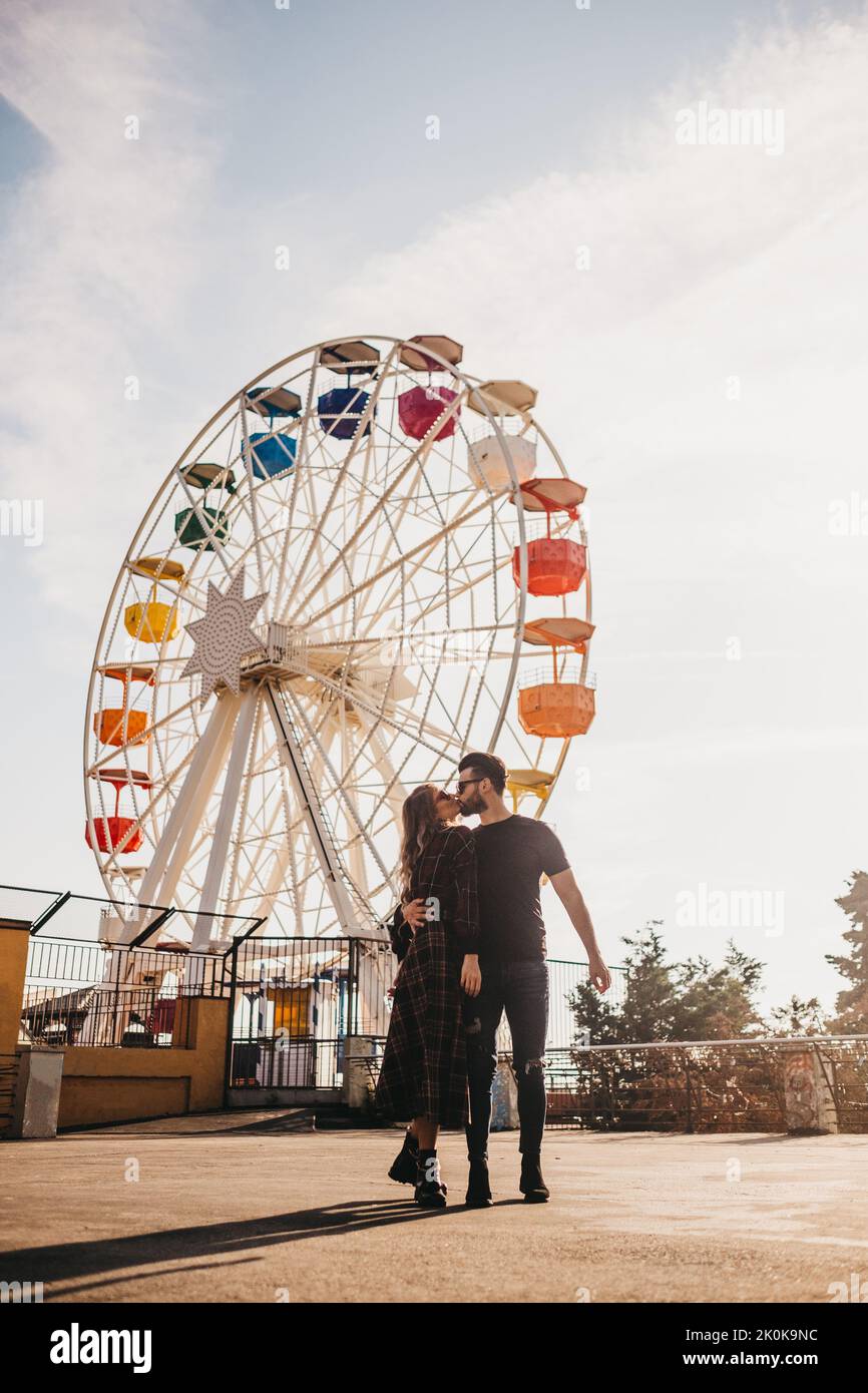 couple kissing each other on a date in a funfair in Barcelona, Spain ...