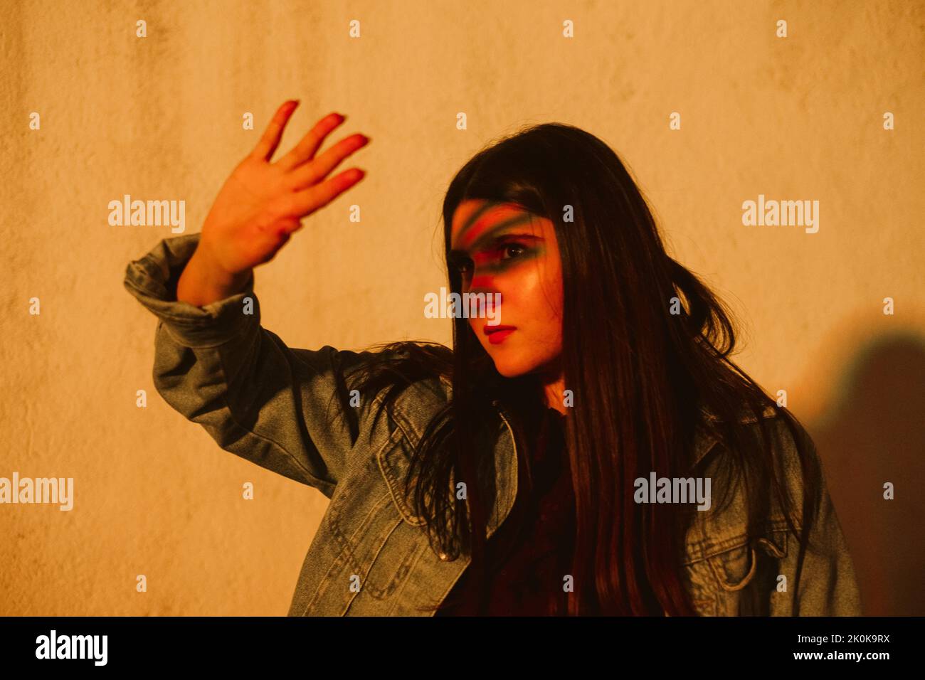 woman protecting eyes from bright light with hand outdoors Stock Photo ...