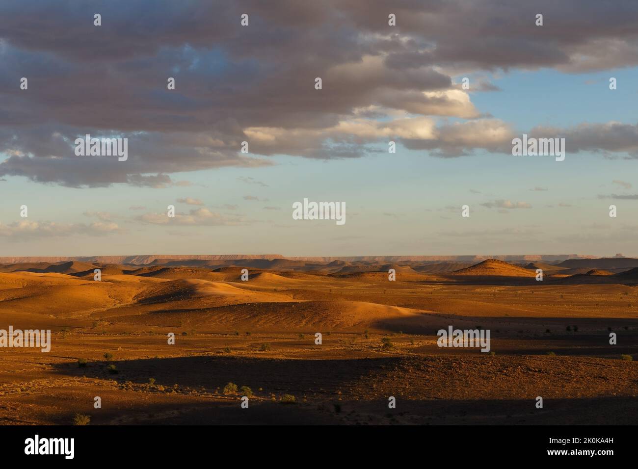 Sunset in the Sahara desert. Top view of the valley. Rocky hills and ...