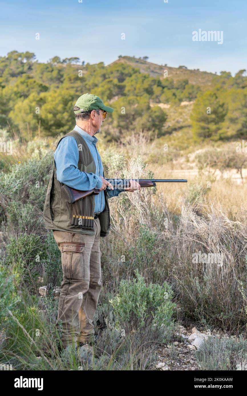 Hunter holding rifle looking away hi-res stock photography and images ...