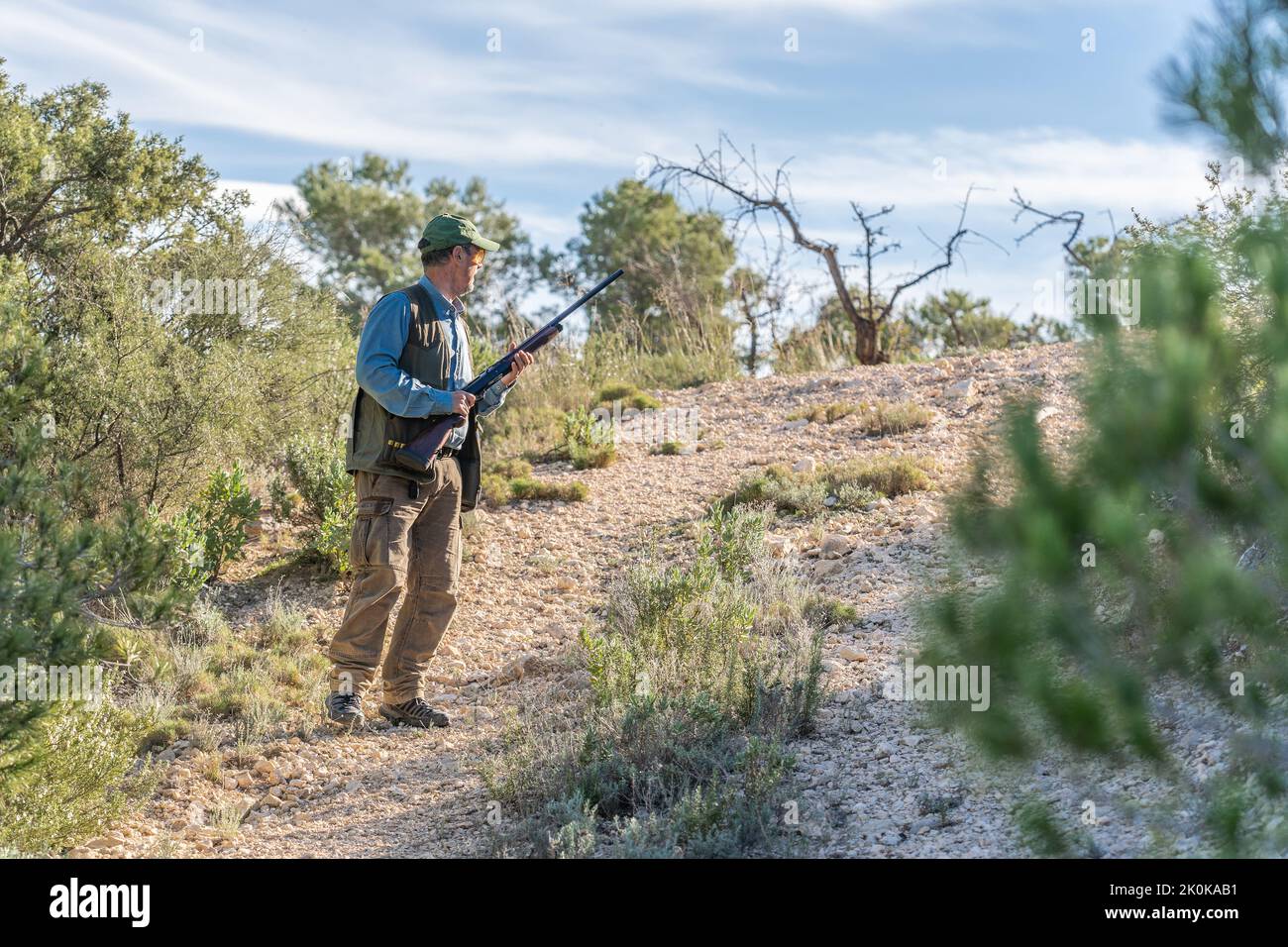 Hunter holding rifle looking away hi-res stock photography and images ...