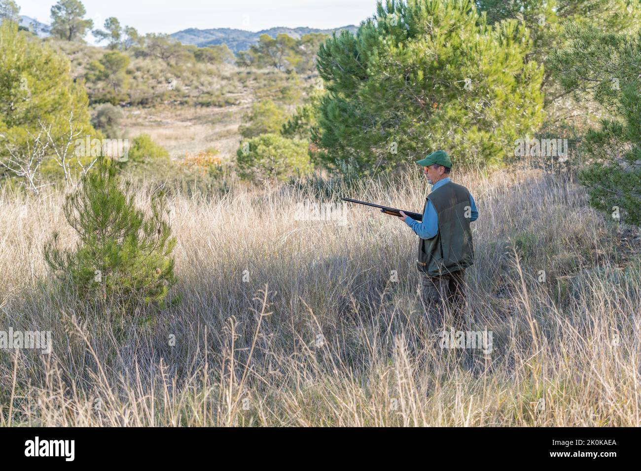 Hunter holding rifle looking away hi-res stock photography and images ...