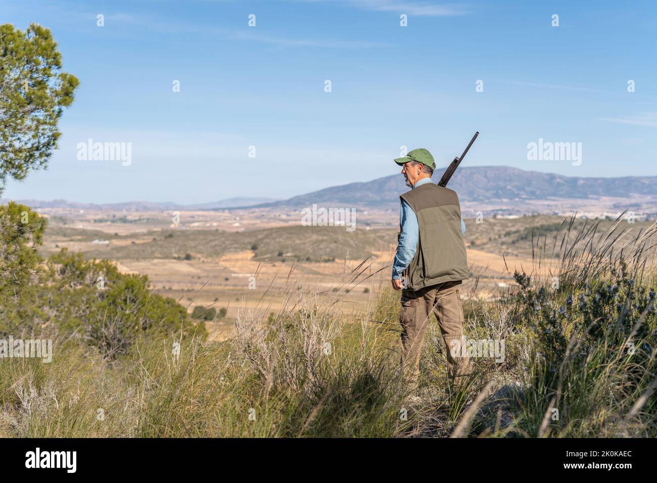 Hunter holding rifle looking away hi-res stock photography and images ...