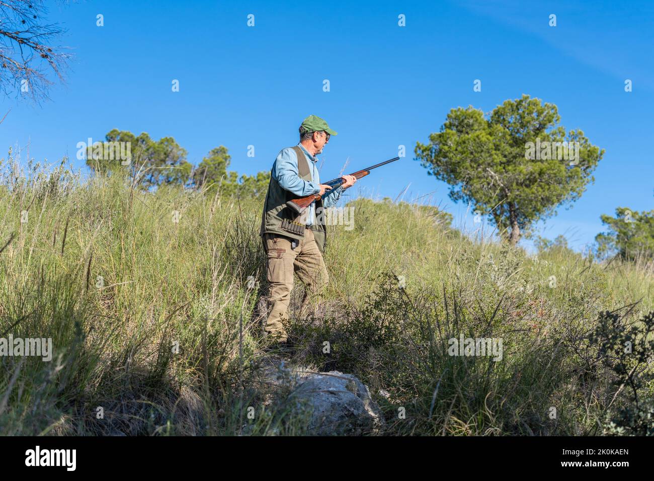 Hunter holding rifle looking away hi-res stock photography and images ...
