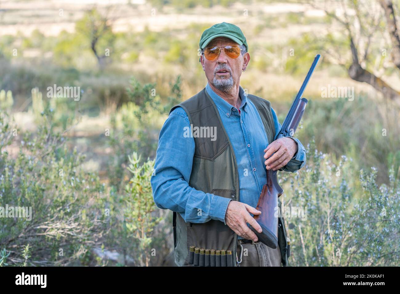 Hunter holding rifle looking away hi-res stock photography and images ...